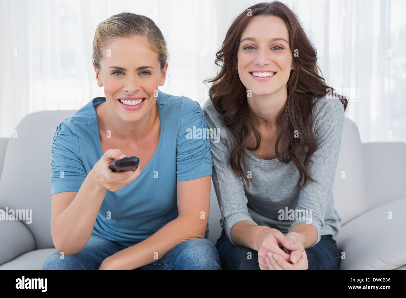 Cheerful women watching television Stock Photo - Alamy