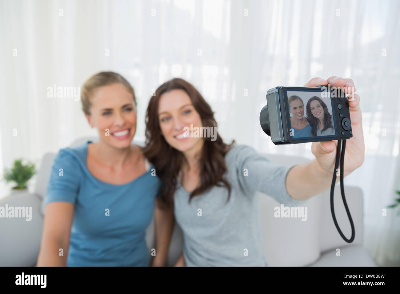 Friends taking pictures with camera Stock Photo - Alamy