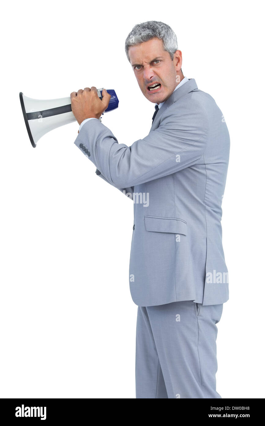Furious businessman posing with loudspeaker Stock Photo - Alamy