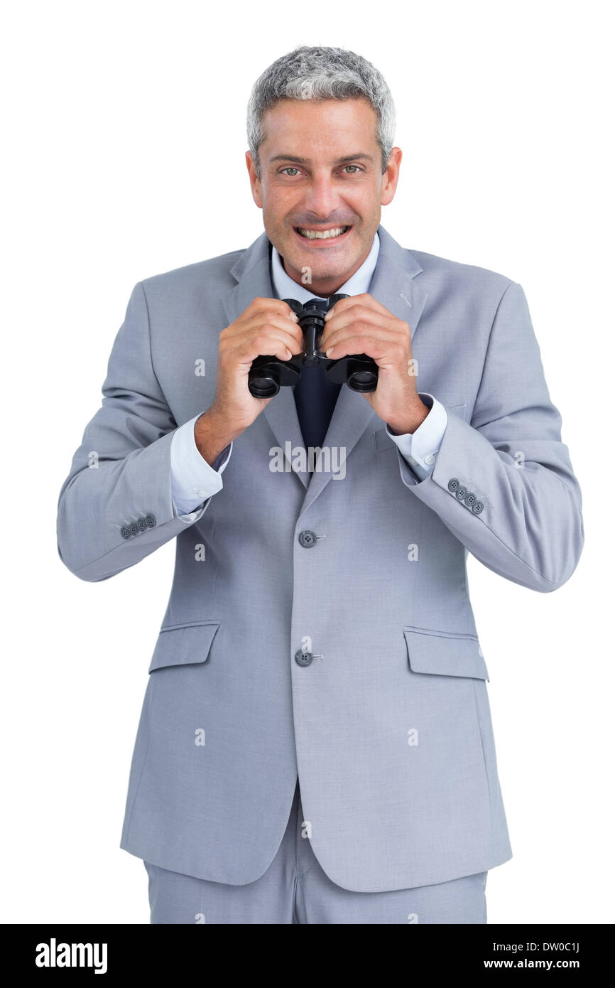 Cheerful businessman observing with binoculars Stock Photo - Alamy