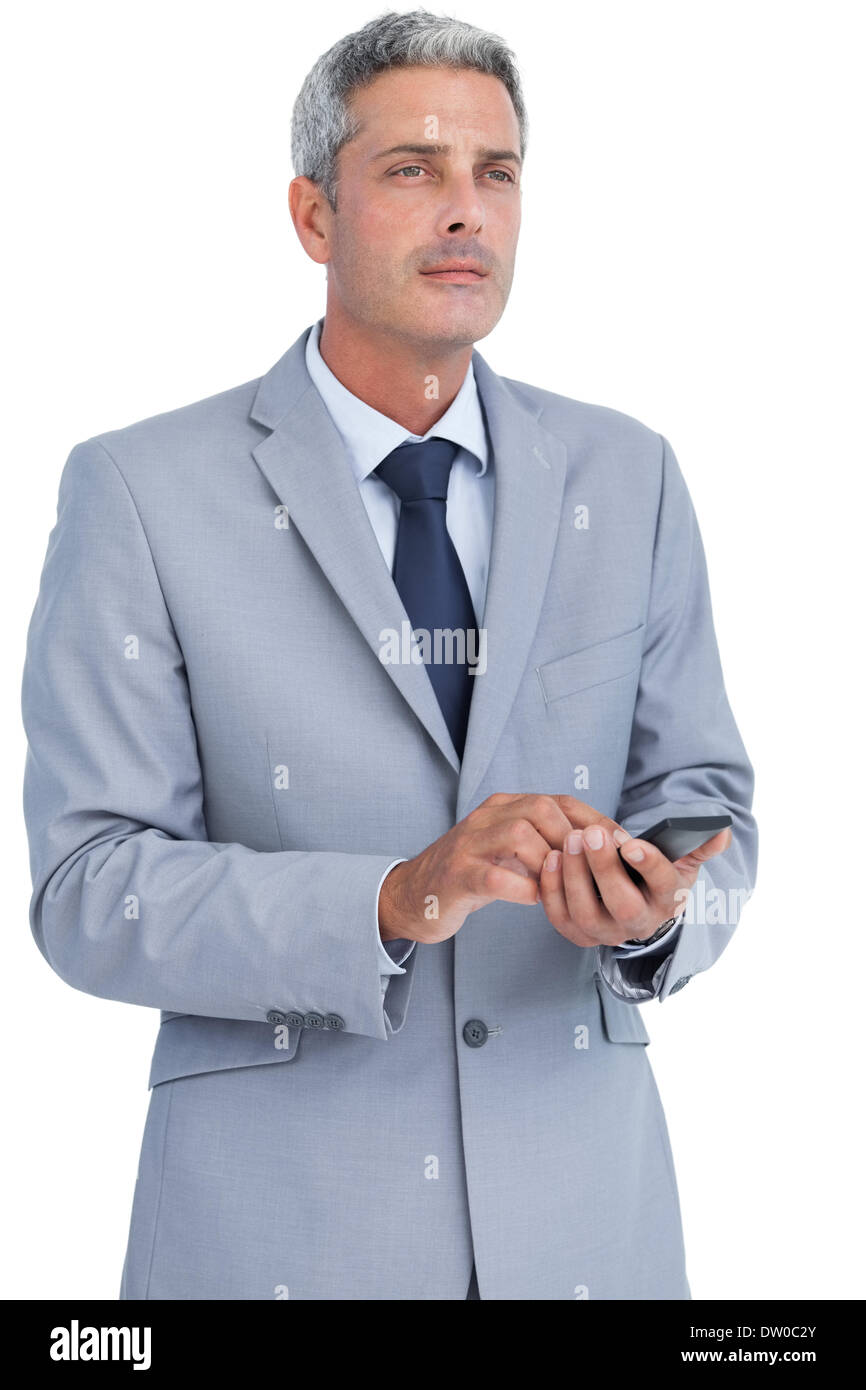 Thoughtful businessman sending text message Stock Photo - Alamy Thoughtful businessman sending text message Stock Photo - Alamy