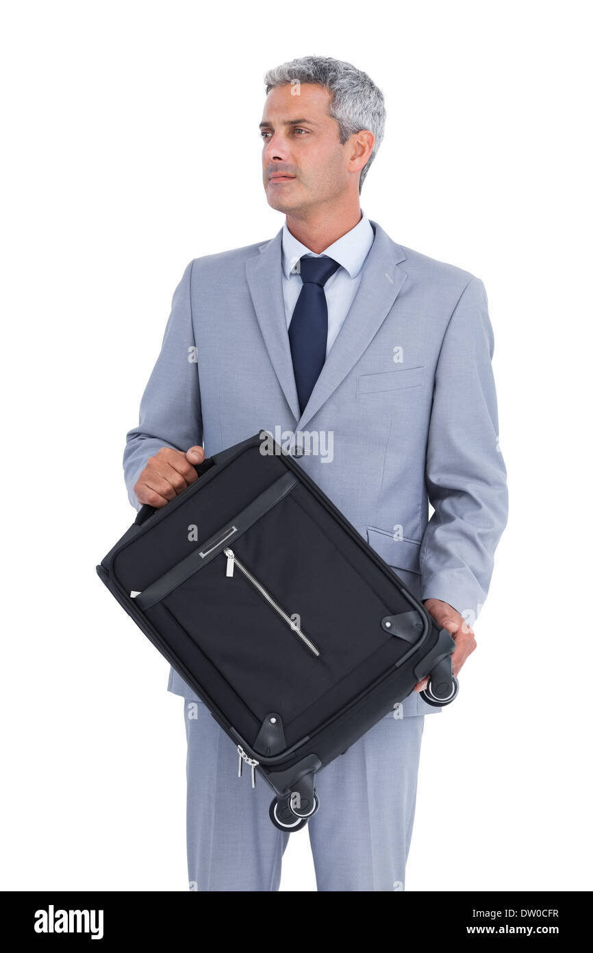 Handsome businessman carrying suitcase Stock Photo - Alamy