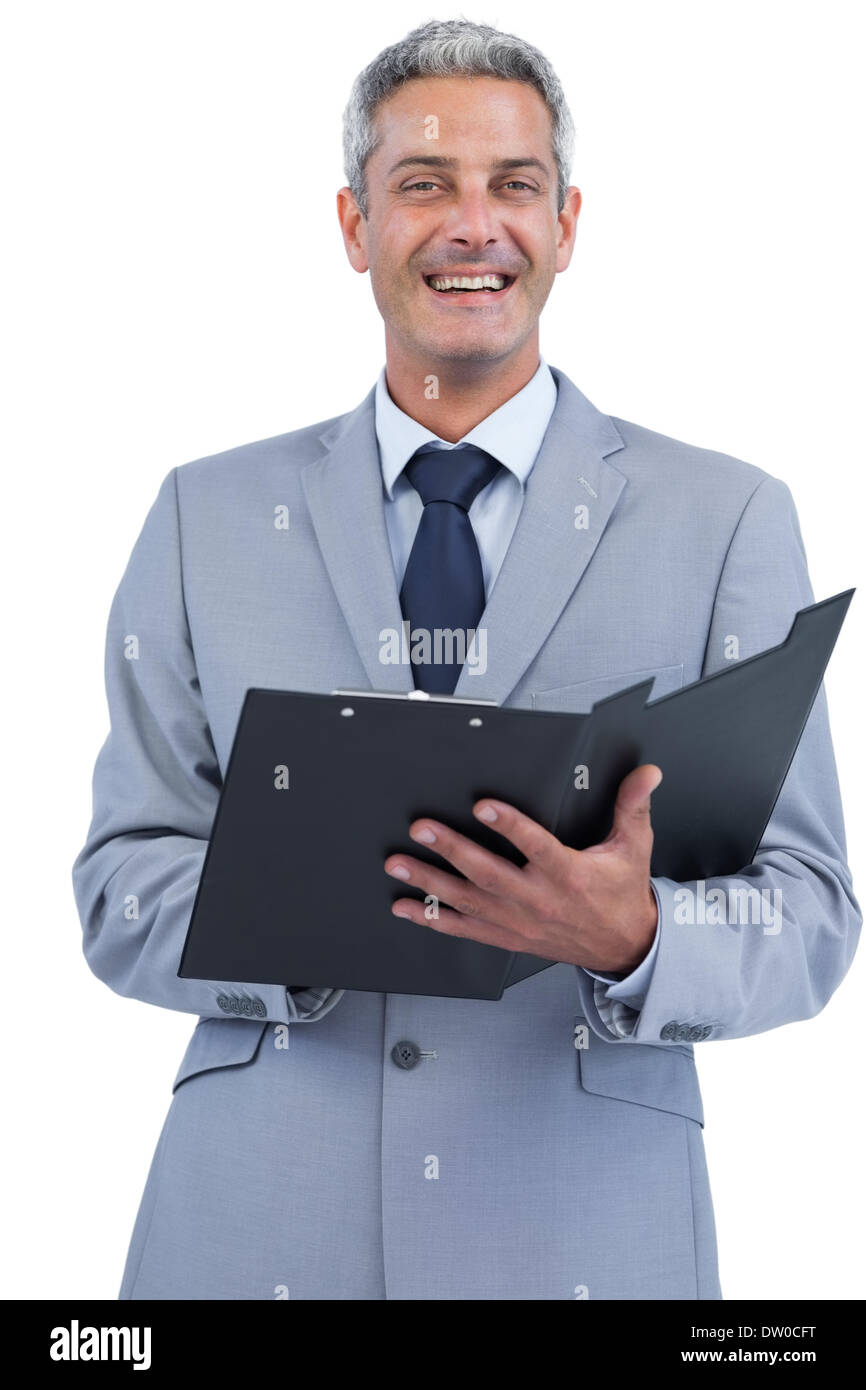 Cheerful businessman holding clipboard Stock Photo - Alamy