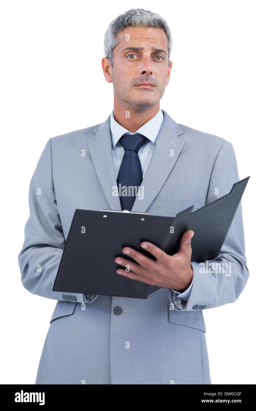 Self assured businessman with clipboard Stock Photo - Alamy