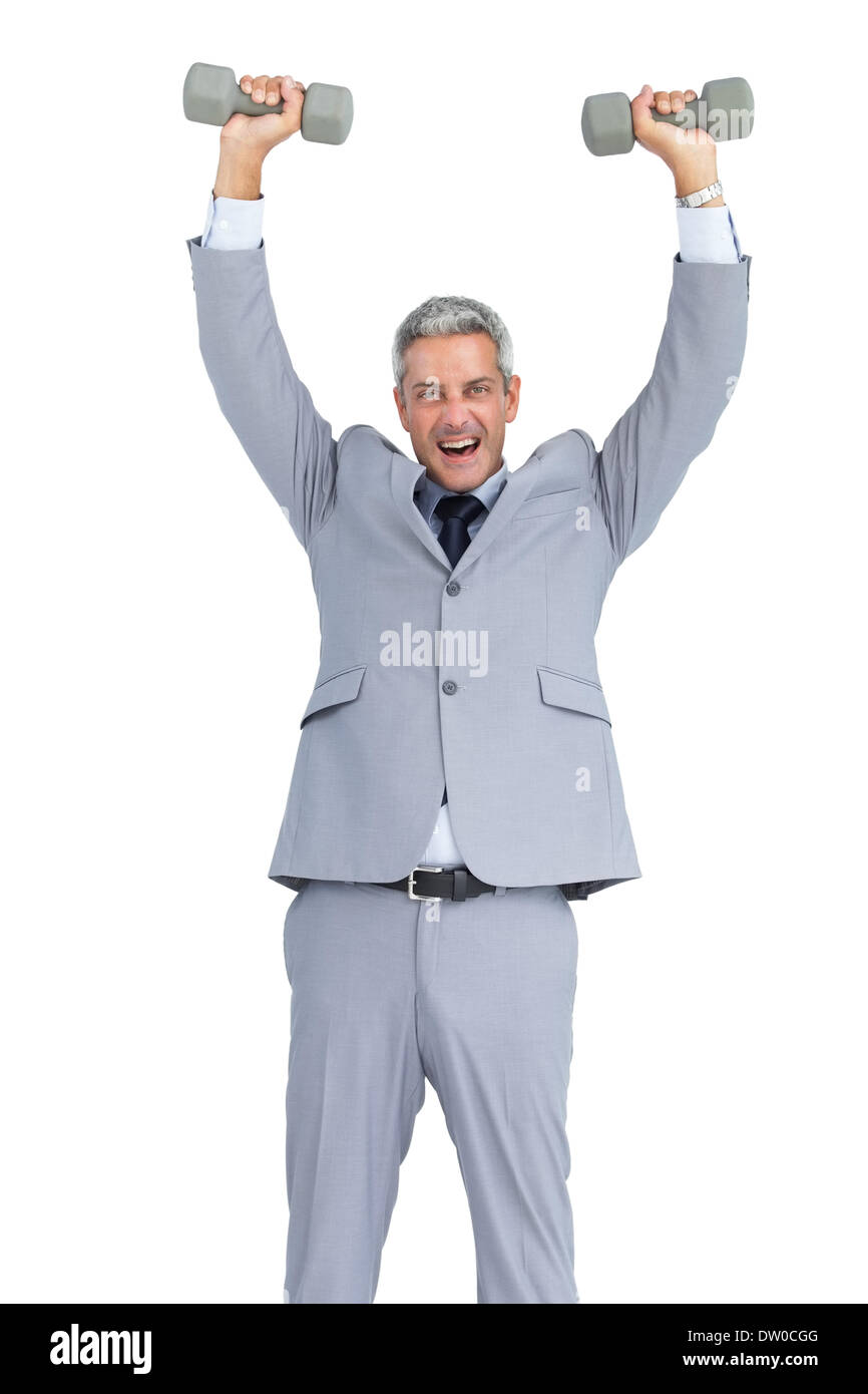 Strong businessman lifting heavy dumbbells Stock Photo - Alamy
