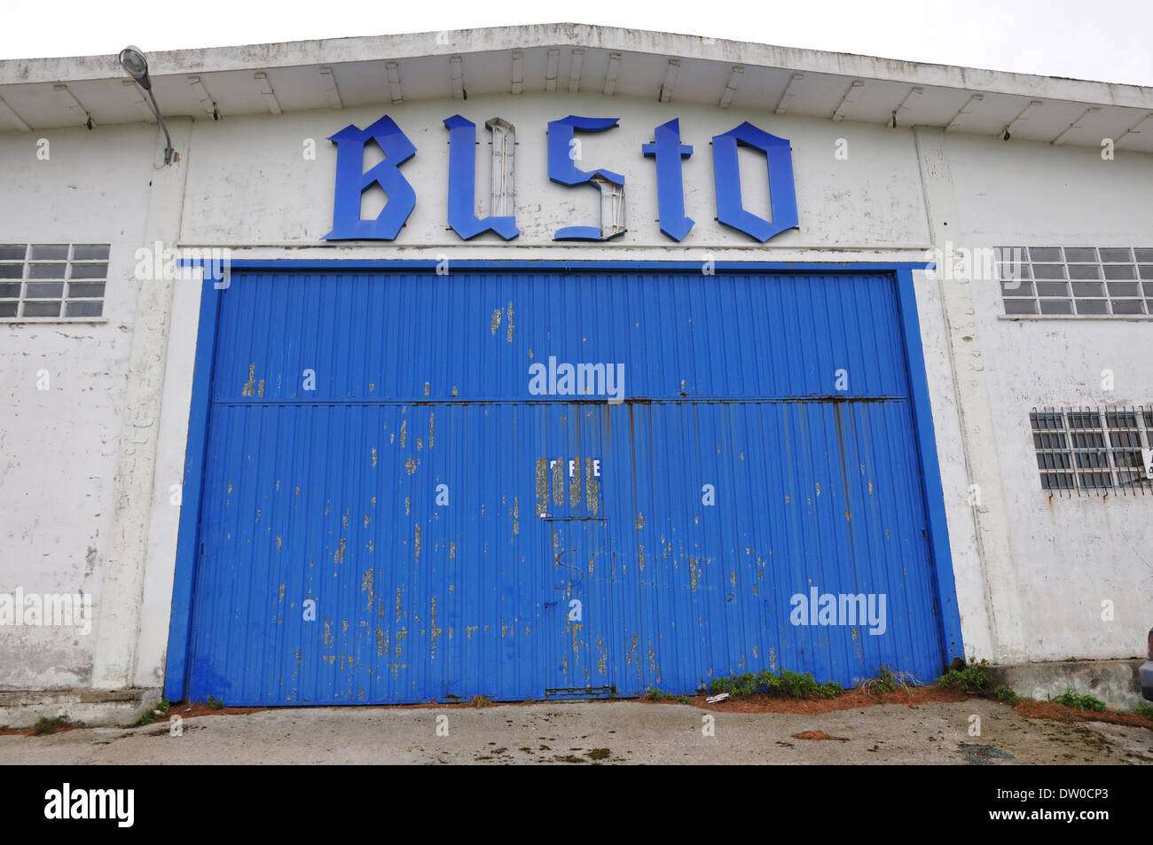 Closed blue doors to white factory building hi-res stock photography ...