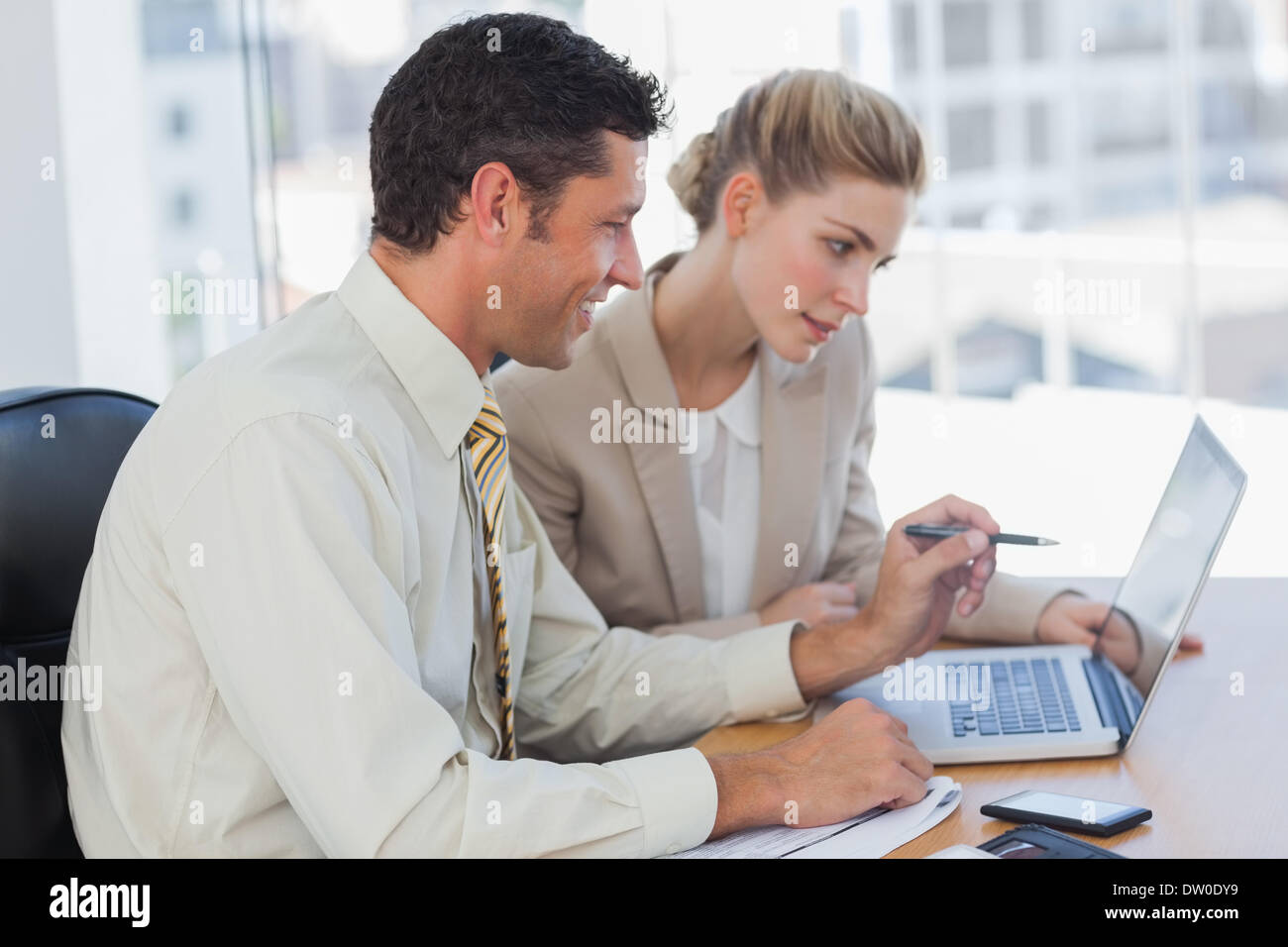 Workmates working together on their computer Stock Photo - Alamy