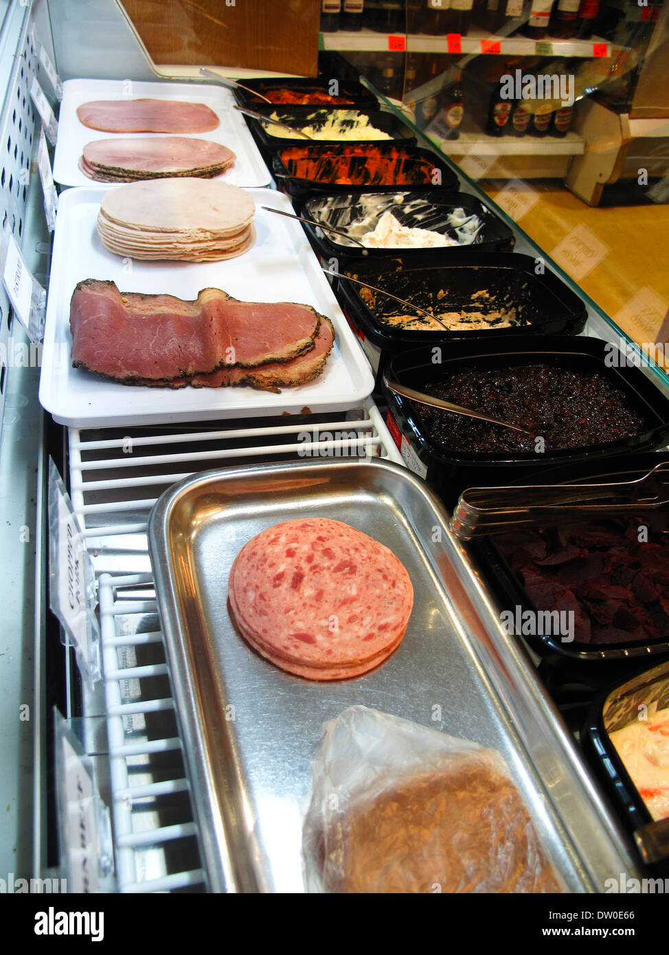 Chilled counter with cold cuts in shop Stock Photo - Alamy