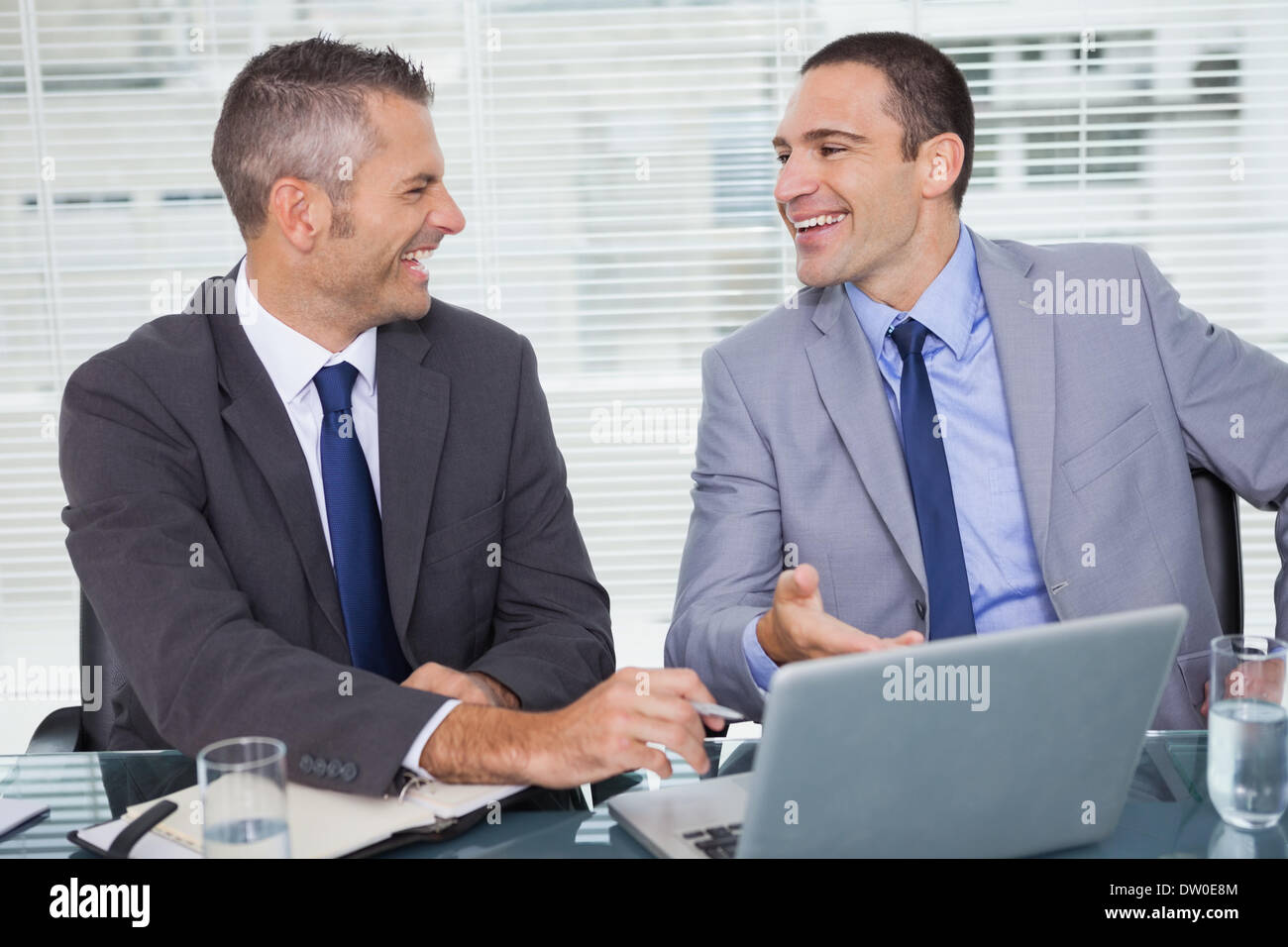 Coworkers laughing together office desk hi-res stock photography and ...