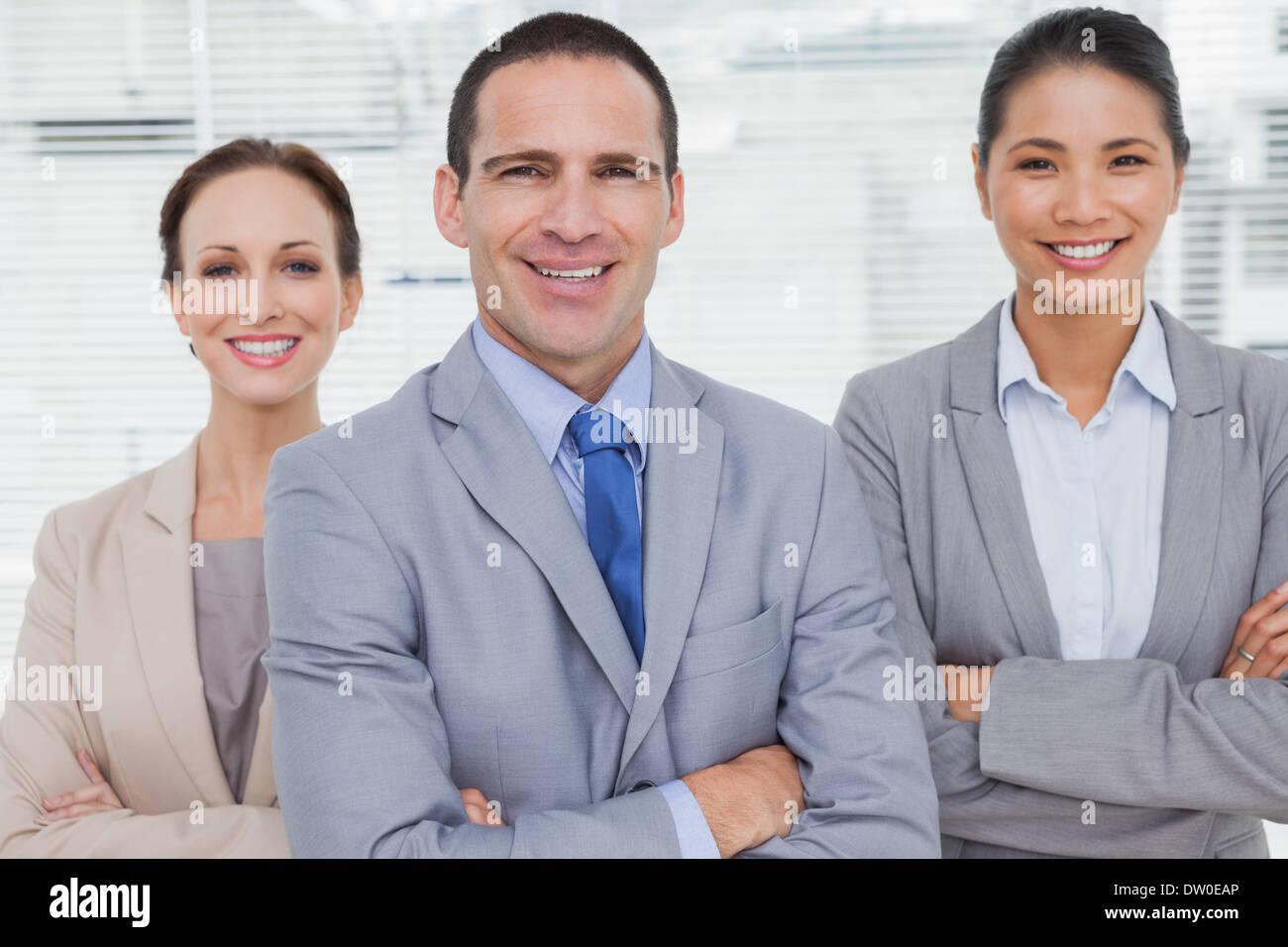 Happy businessman crossing arms smiling hi-res stock photography and ...