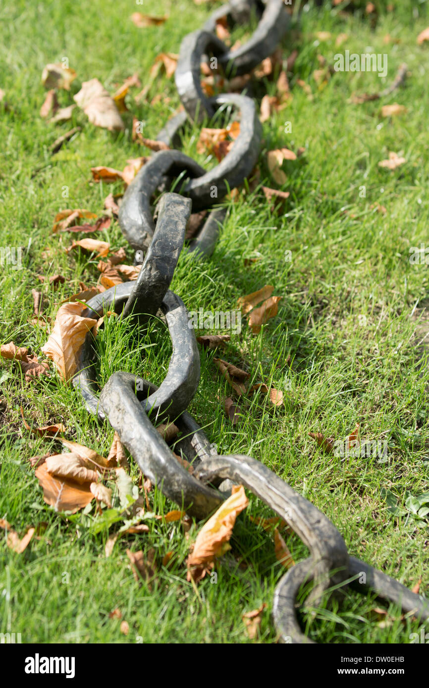 Heavy chain on grass Stock Photo - Alamy