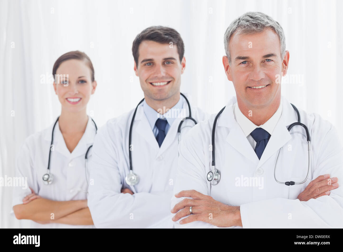 Smiling doctors posing together Stock Photo - Alamy