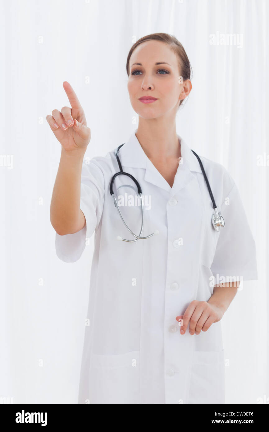 Smiling nurse pointing at something Stock Photo - Alamy