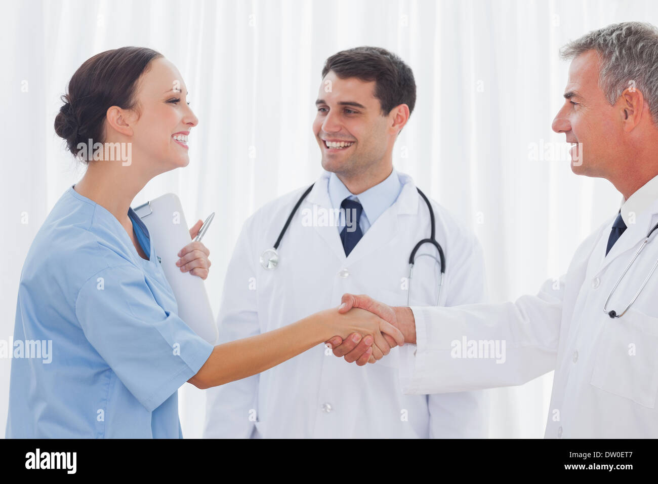 Surgeon thanking the doctor for helping her Stock Photo - Alamy