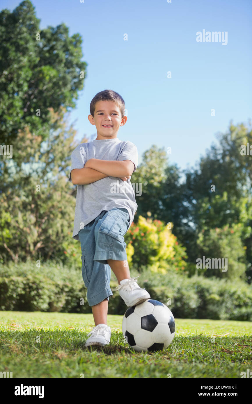 Young boy posing with football Stock Photo - Alamy