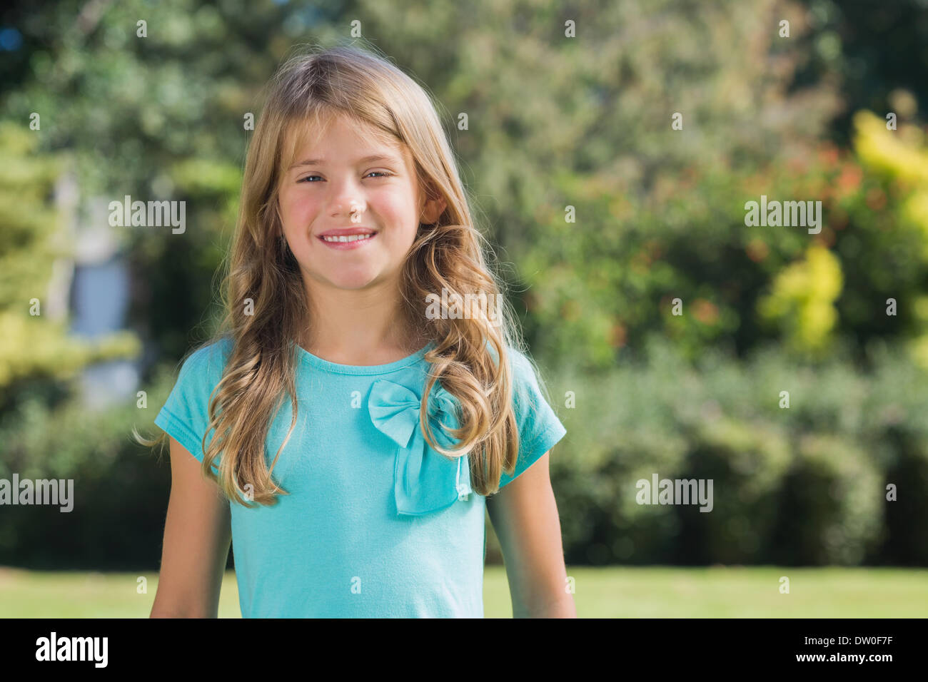 Cute girl smiling at camera Stock Photo - Alamy