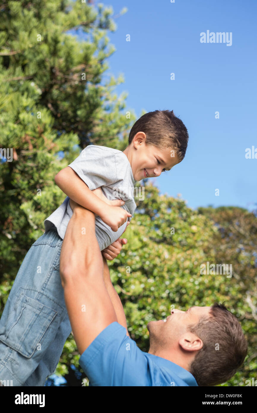 Father lifting up his son Stock Photo - Alamy