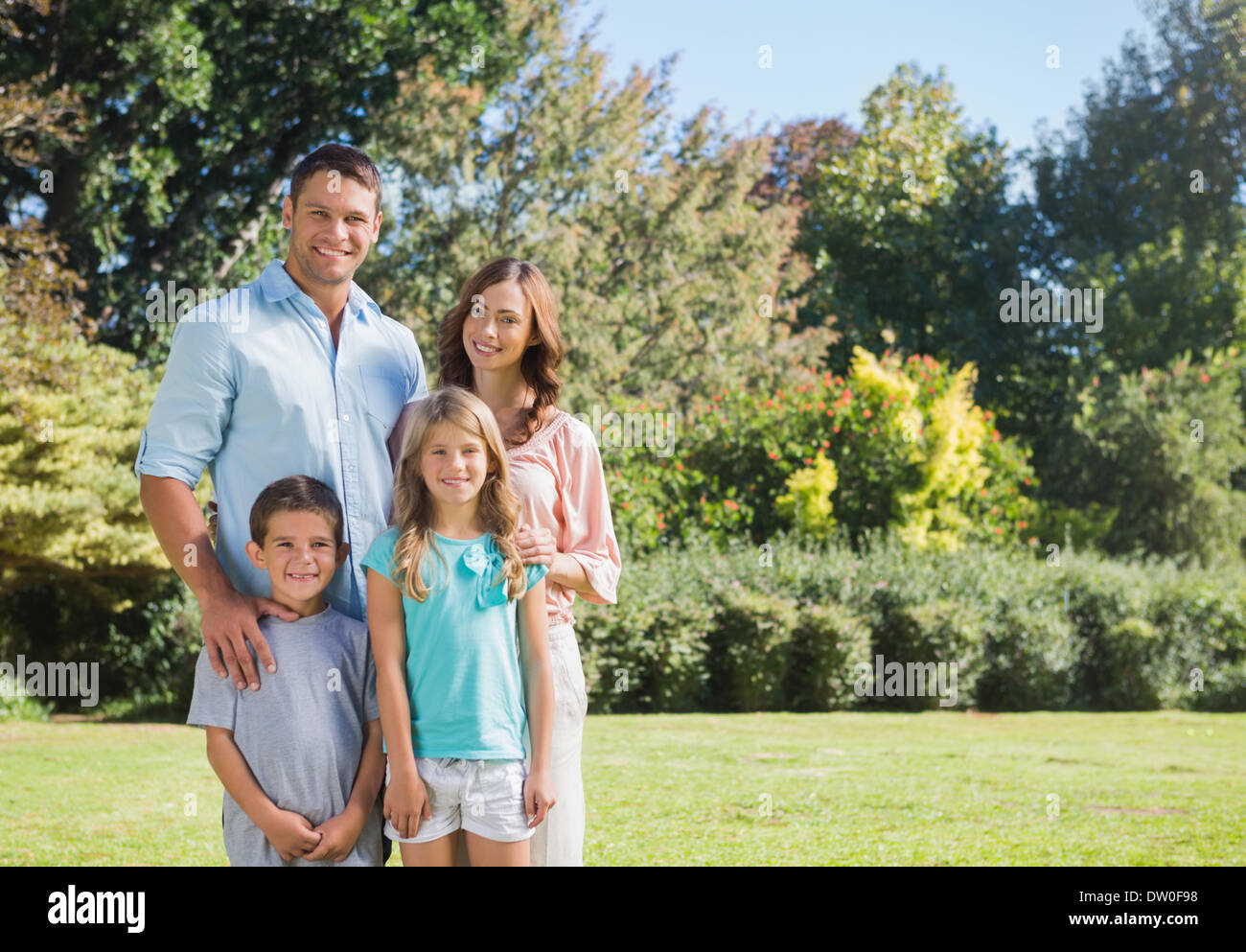 Family standing in green park hi-res stock photography and images - Alamy