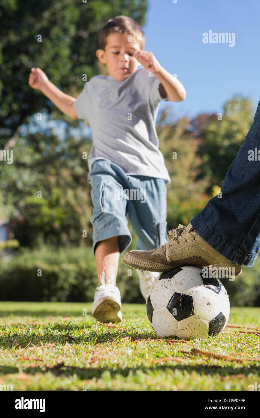 Boy kicking the football Stock Photo - Alamy