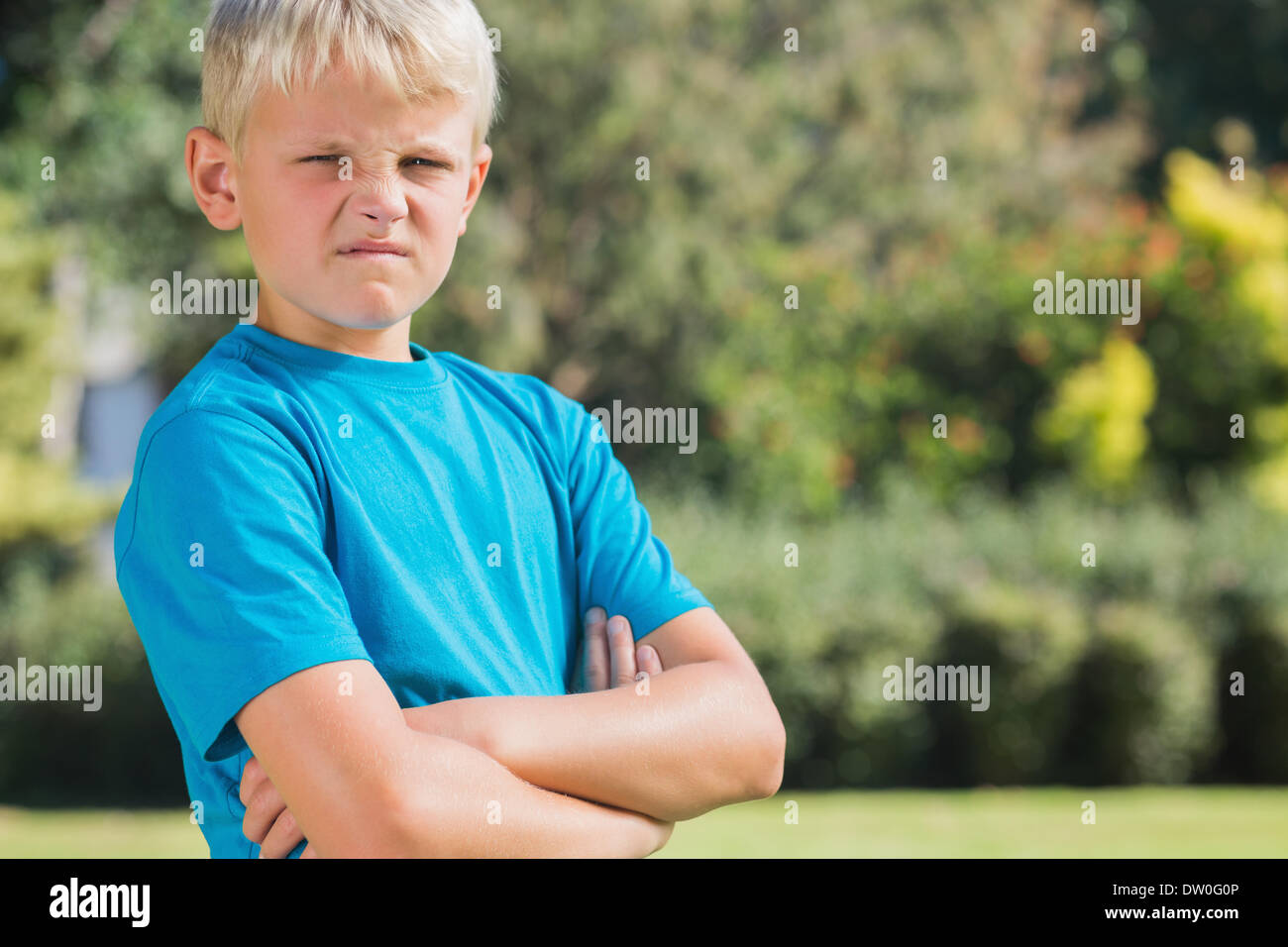 Blonde boy looking angry Stock Photo - Alamy