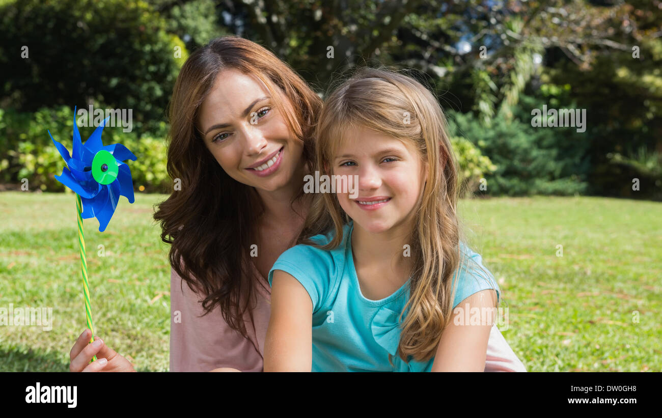 Happy mother and daughter holding pinwheel Stock Photo - Alamy