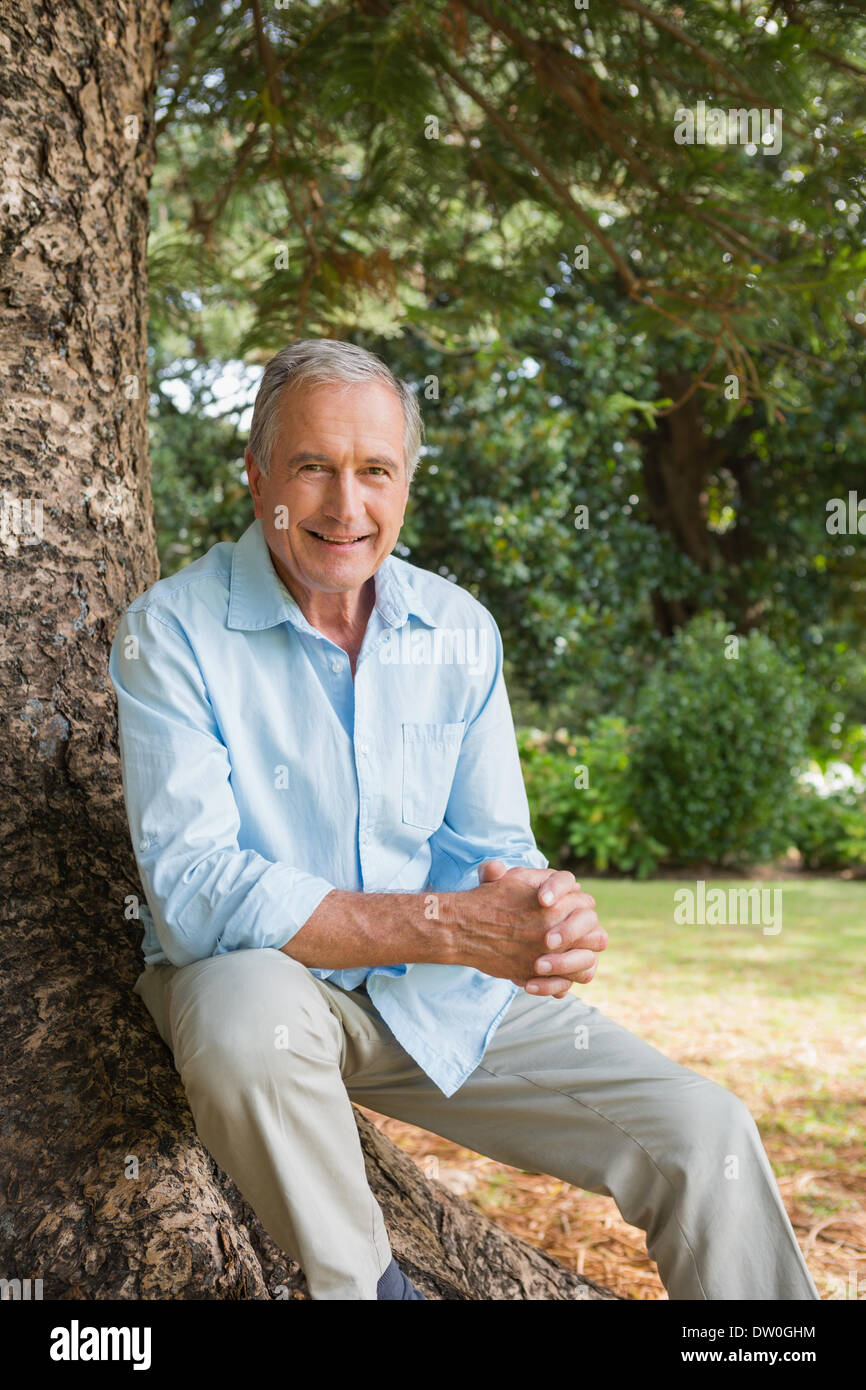Man sitting on tree trunk hi-res stock photography and images - Alamy