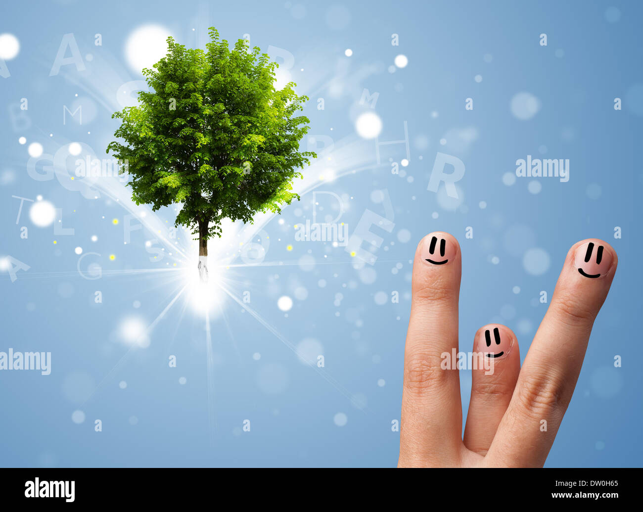 Happy finger smileys with green magical glowing tree Stock Photo - Alamy