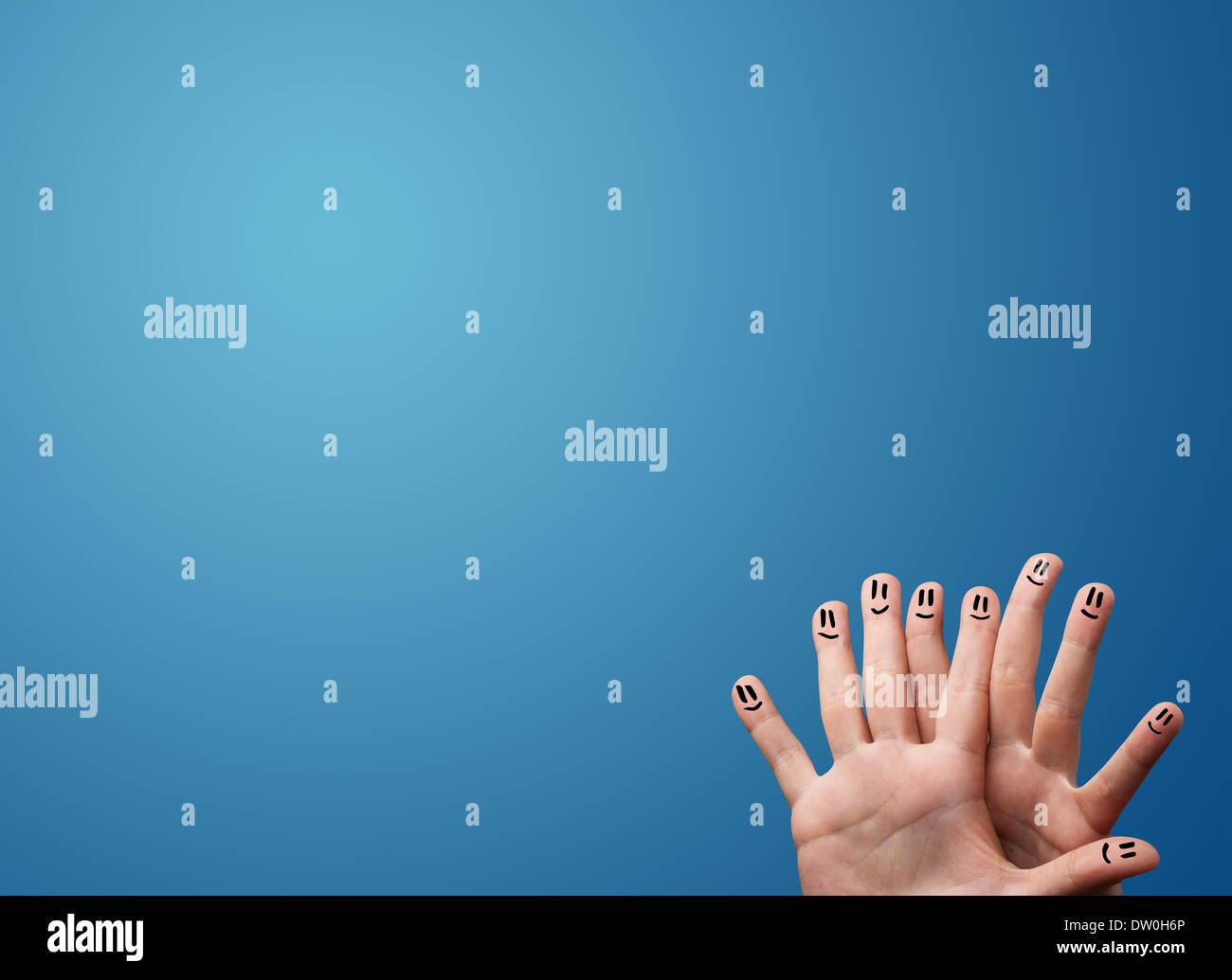 Happy smiley face fingers looking at empty blue background copy space ...