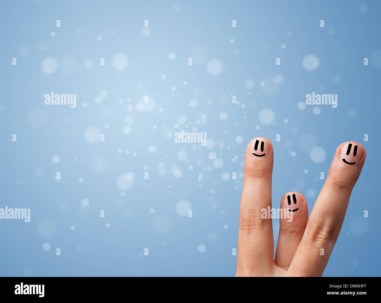 Happy finger smileys with empty blue bokeh background Stock Photo - Alamy