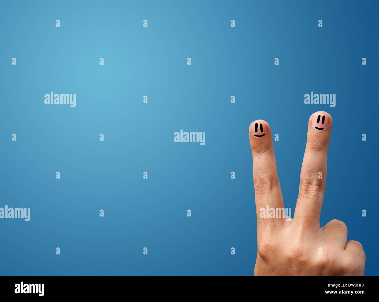 Happy smiley face fingers looking at empty blue background copy space ...