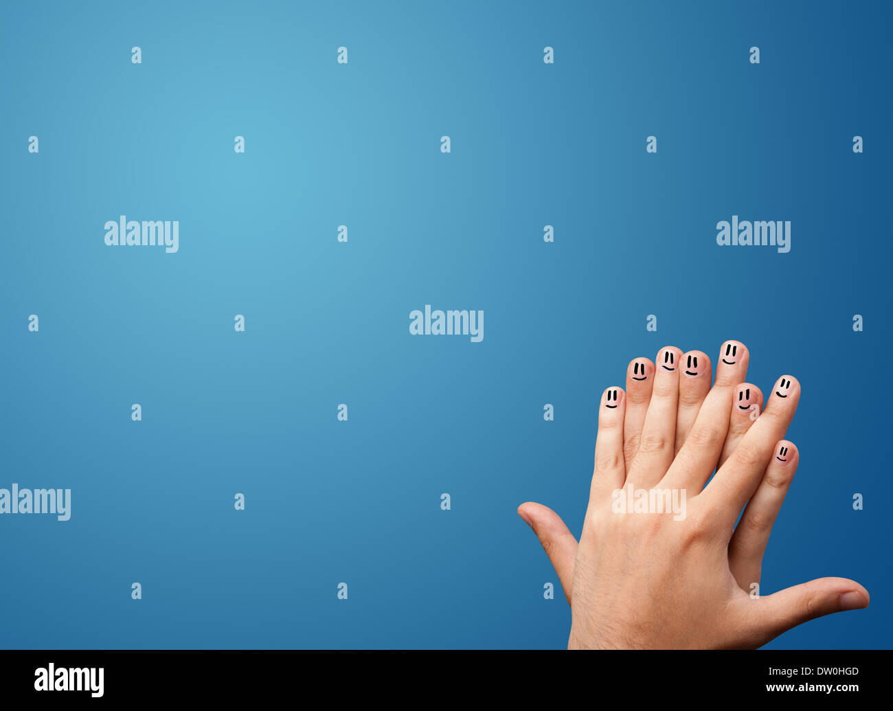 Happy smiley face fingers looking at empty blue background copy space ...