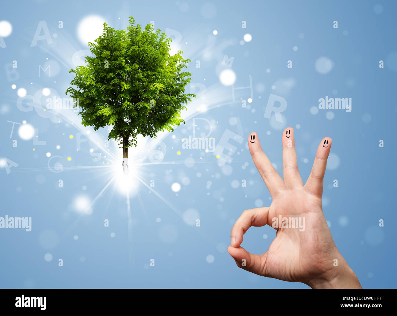 Happy finger smileys with green magical glowing tree Stock Photo - Alamy