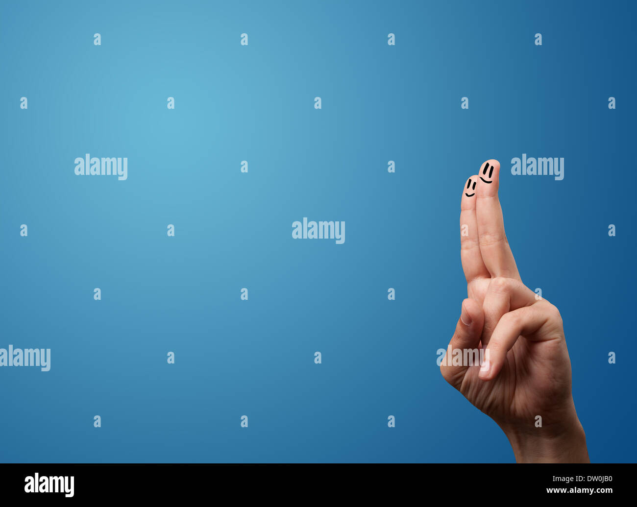 Happy smiley face fingers looking at empty blue background copy space ...