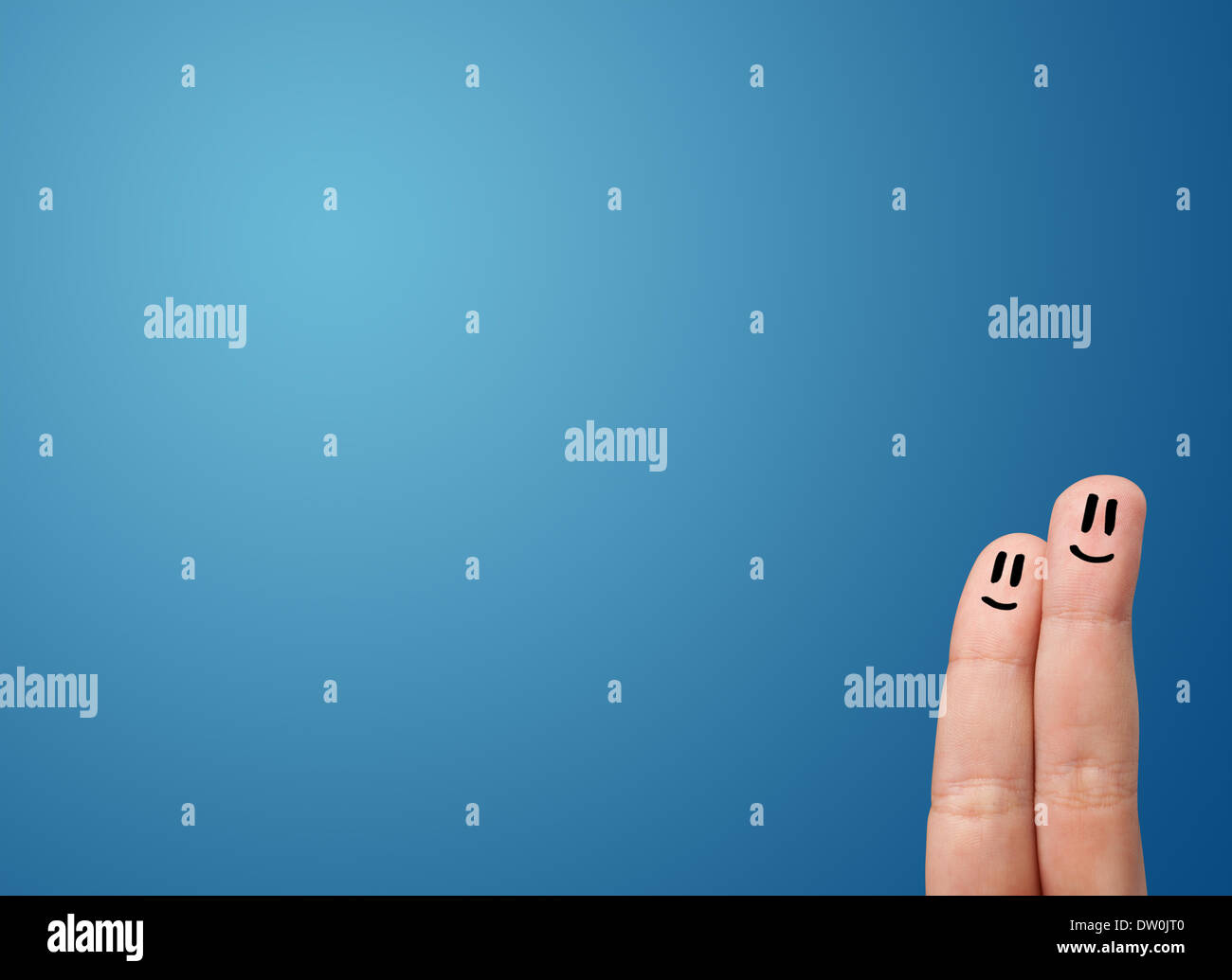 Happy smiley face fingers looking at empty blue background copy space ...