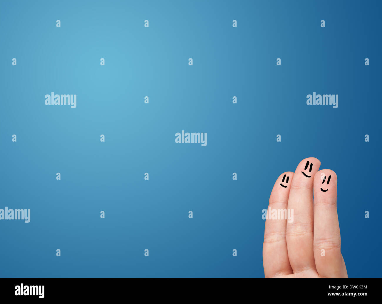 Happy smiley face fingers looking at empty blue background copy space ...