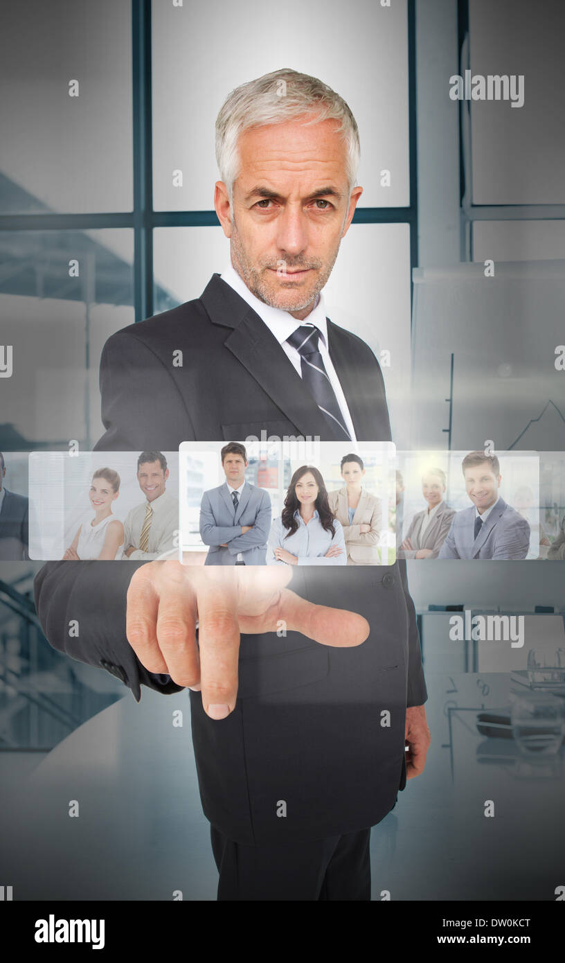 Mature businessman using futuristic interface Stock Photo - Alamy
