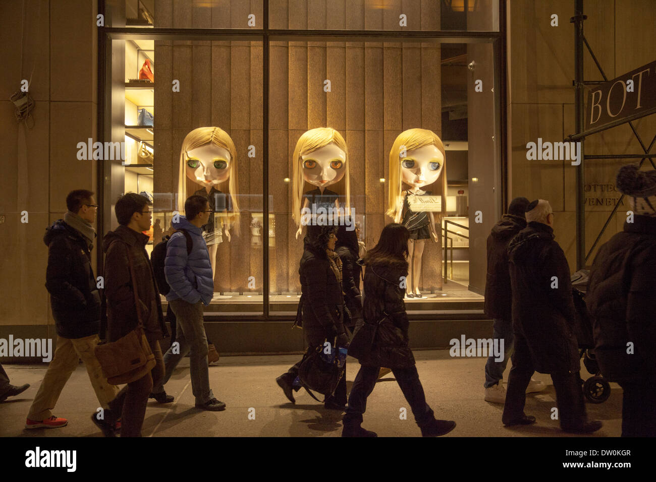 Pedestrians walk by strange attention getting window display on 5th Ave ...