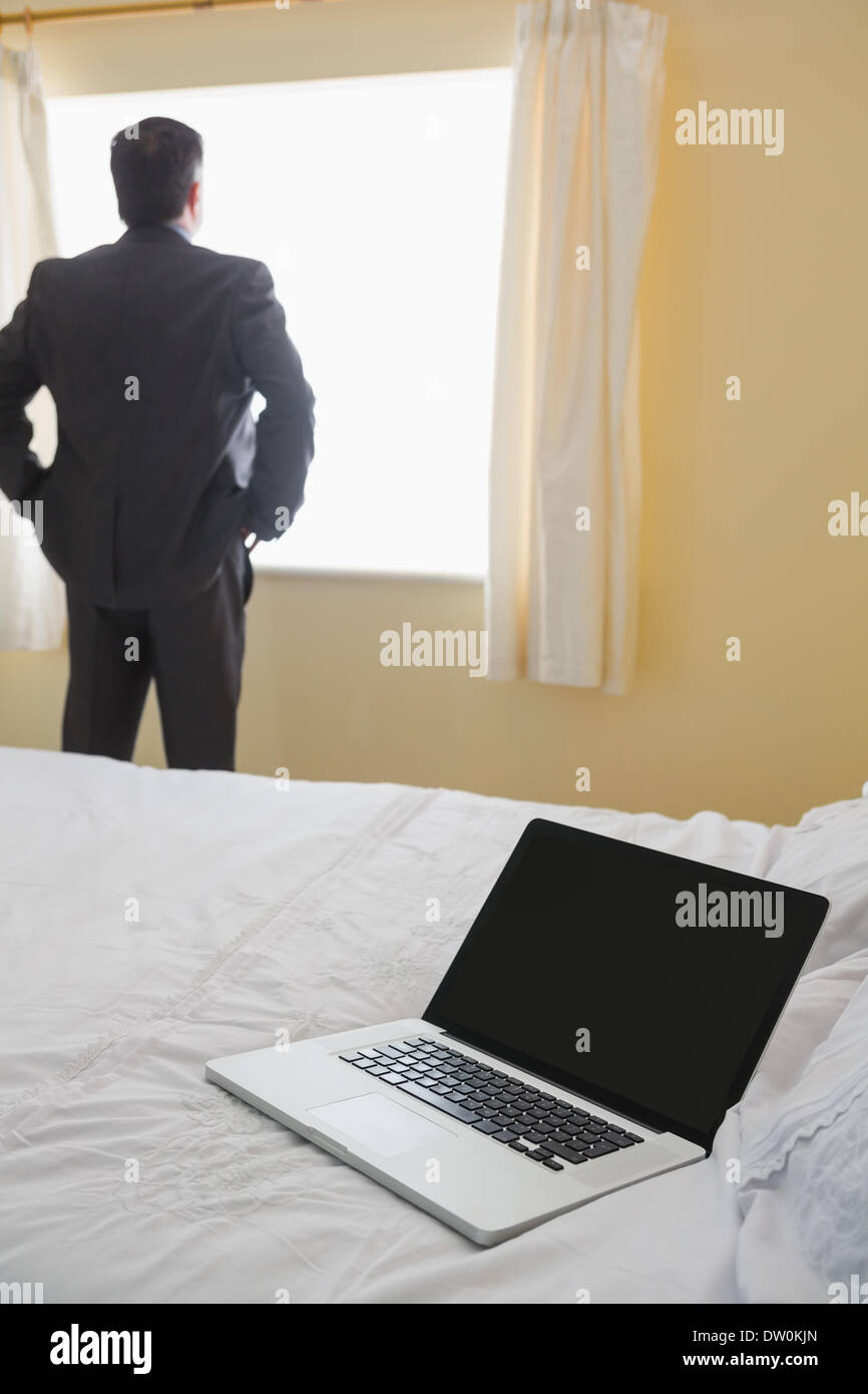 Man standing by the window looking out Stock Photo - Alamy