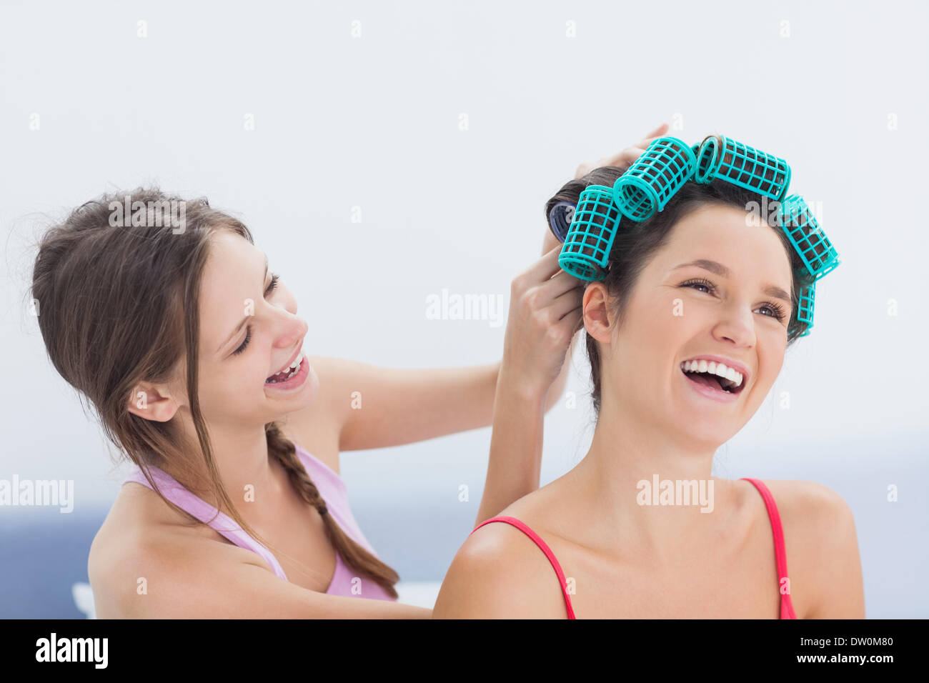 Girl fixing her friends hair rollers Stock Photo - Alamy