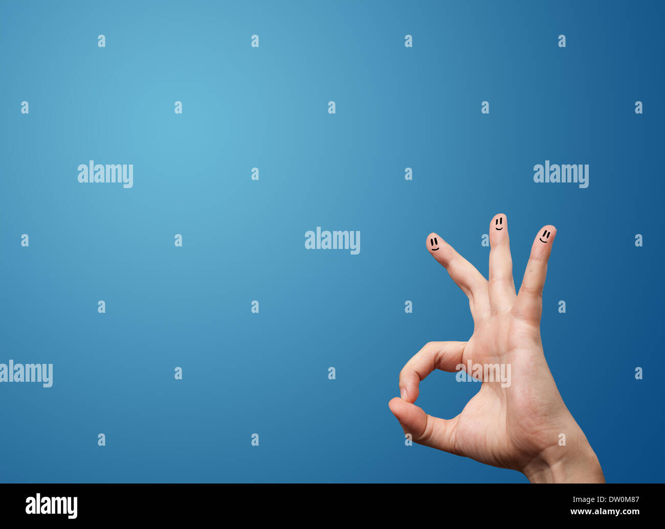 Happy smiley face fingers looking at empty blue background copy space ...