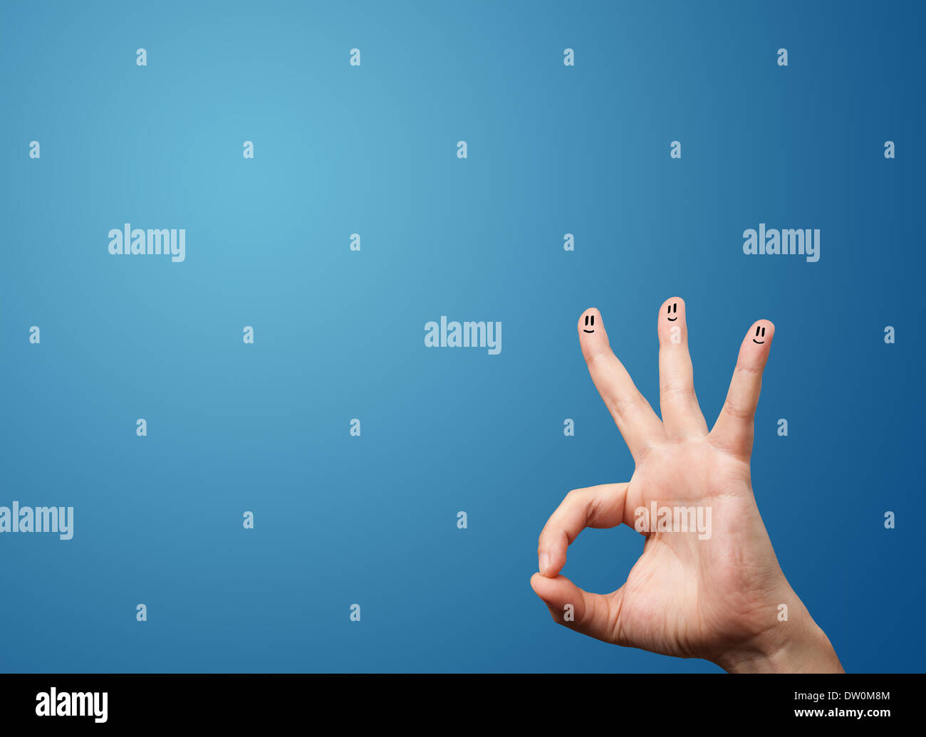 Happy smiley face fingers looking at empty blue background copy space ...