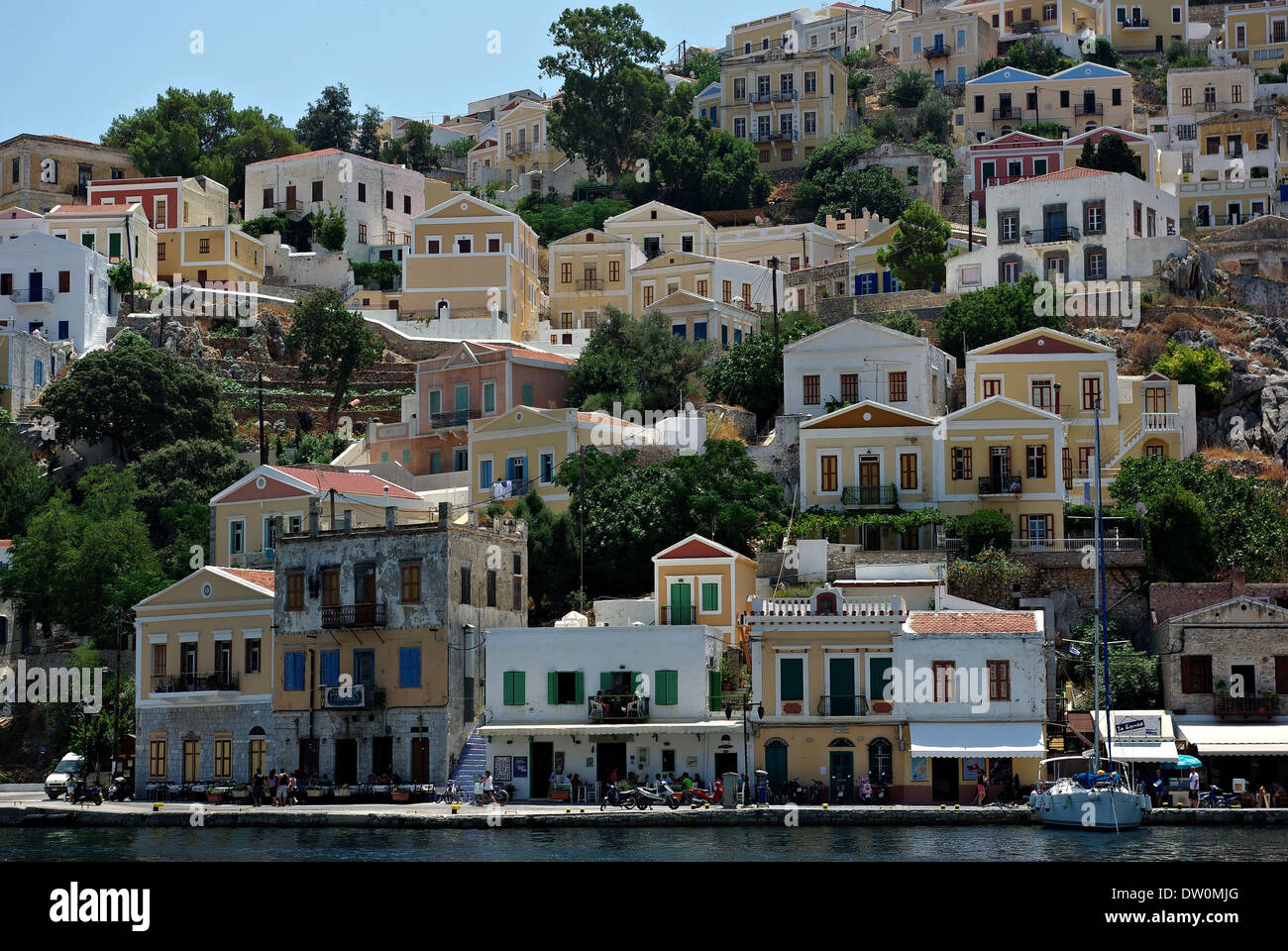Typical greece seaside town with many colorful houses built at hill ...