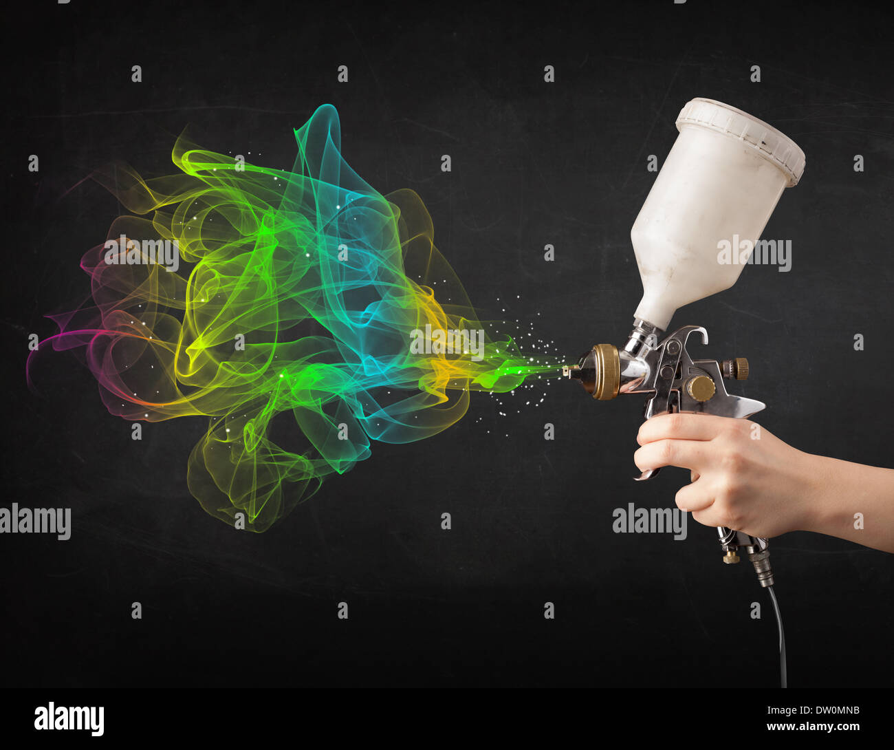 Painter working with airbrush and paints colorful paint Stock Photo - Alamy