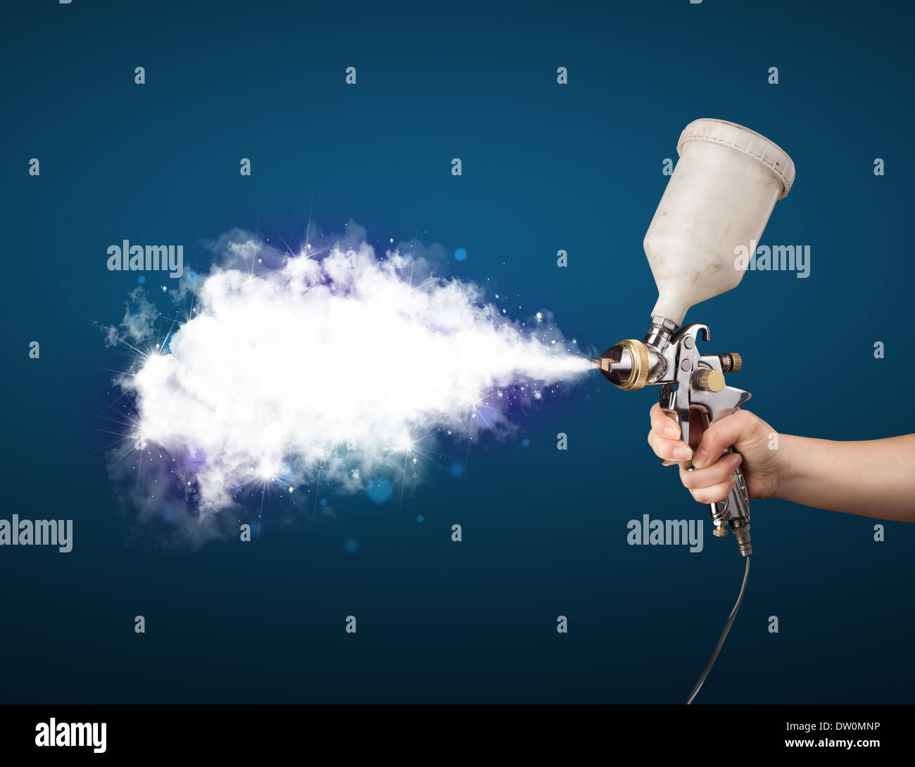 Painter with airbrush gun and white magical smoke Stock Photo - Alamy