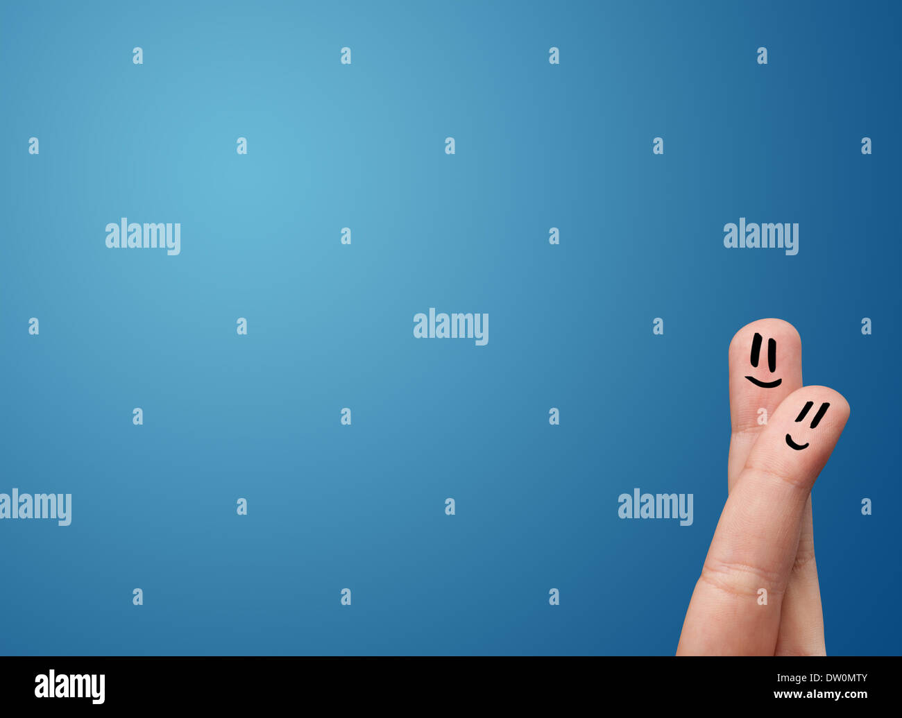 Happy smiley face fingers looking at empty blue background copy space ...