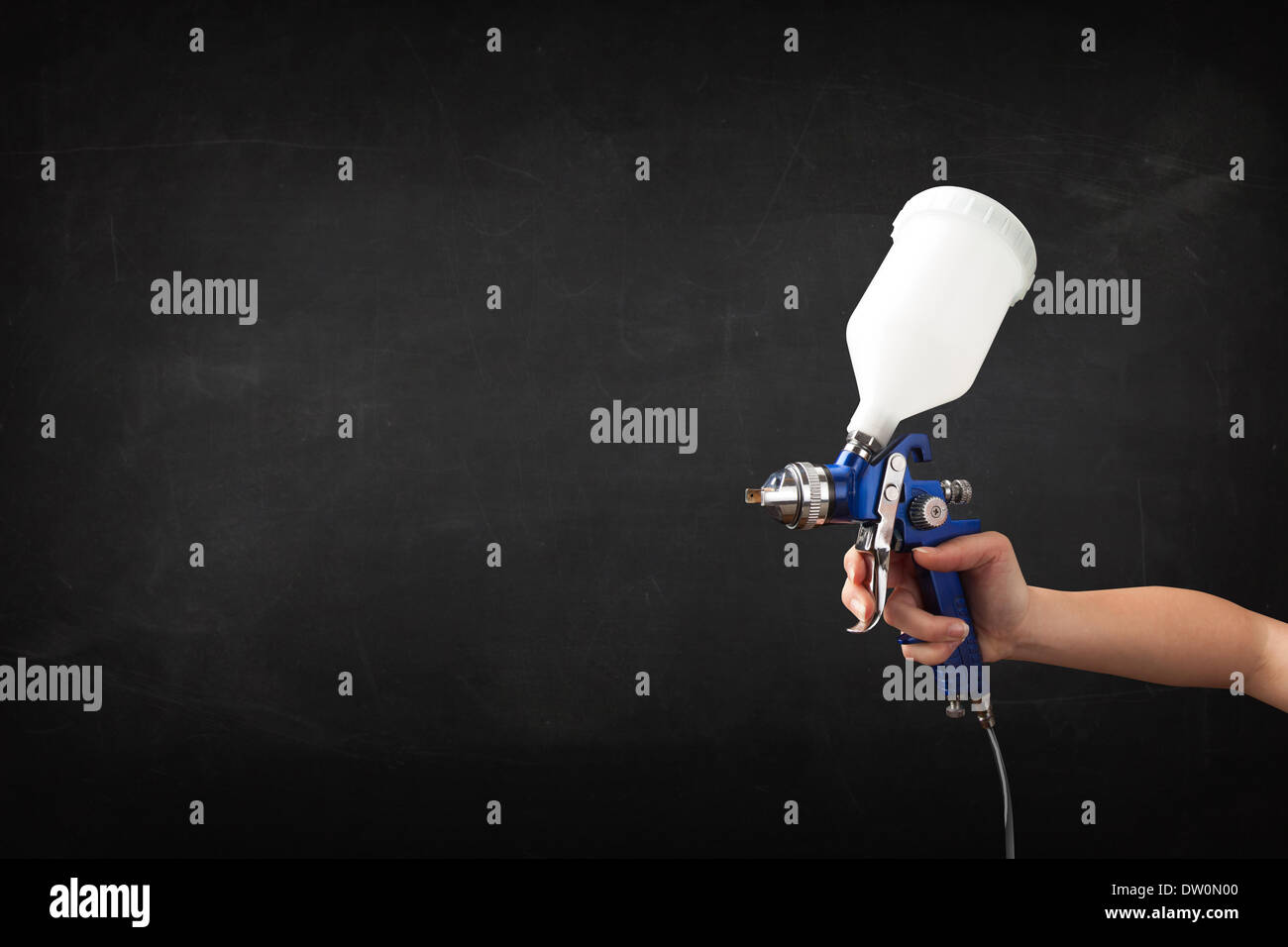 Painter works with airbrush gun and empty copyspace Stock Photo - Alamy