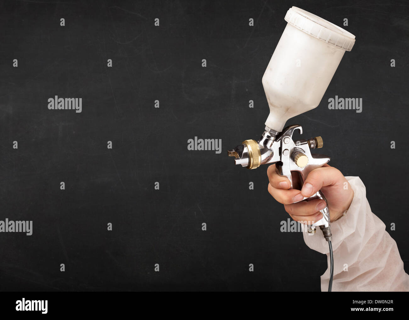 Painter works with airbrush gun and empty copyspace Stock Photo - Alamy