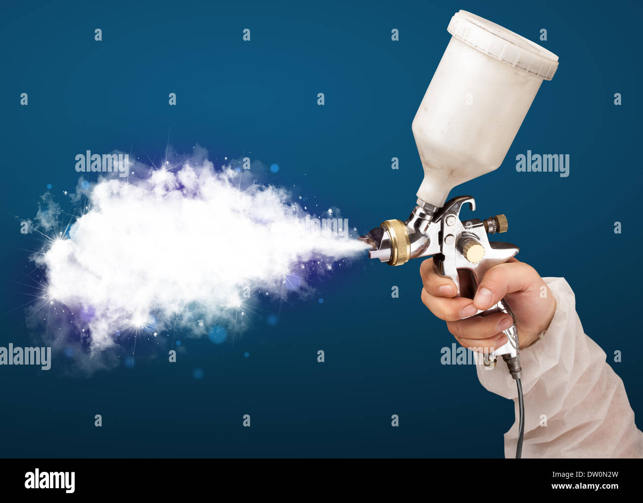 Painter with airbrush gun and white magical smoke Stock Photo - Alamy