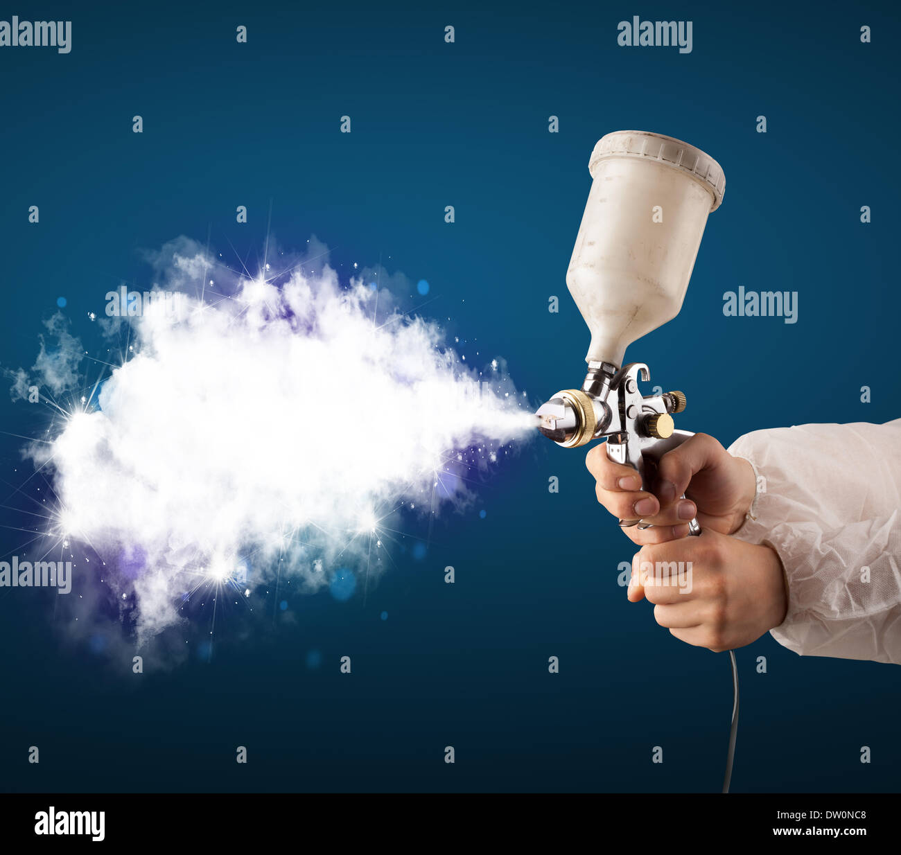 Painter with airbrush gun and white magical smoke Stock Photo - Alamy