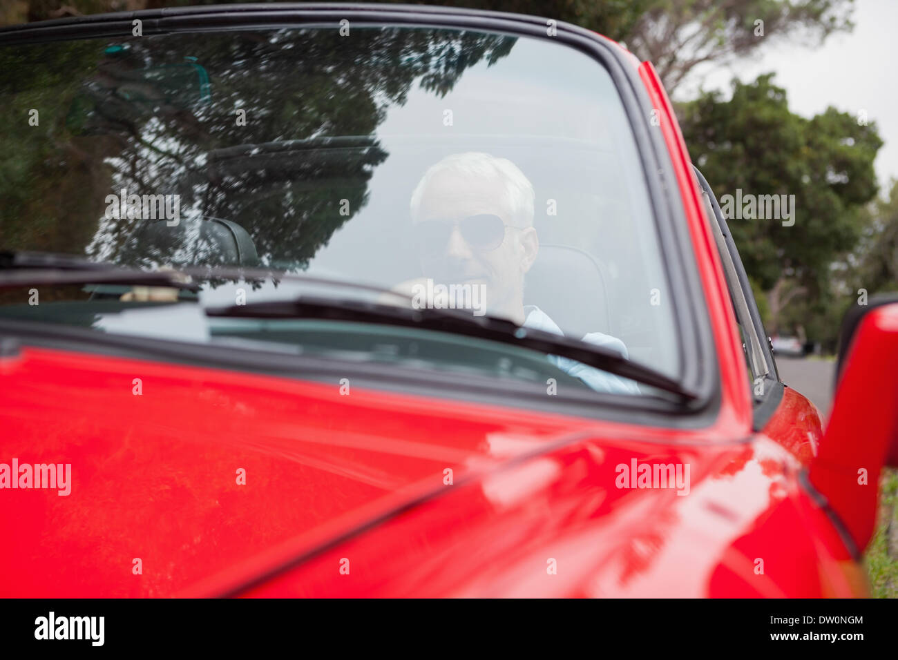 Handsome man driving red convertible Stock Photo - Alamy